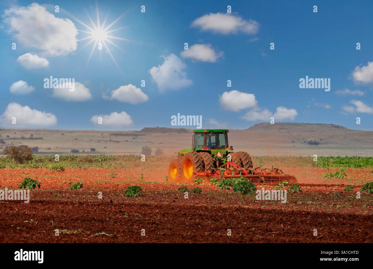tractor with plough in the field plowing the agricultural land Stock ...