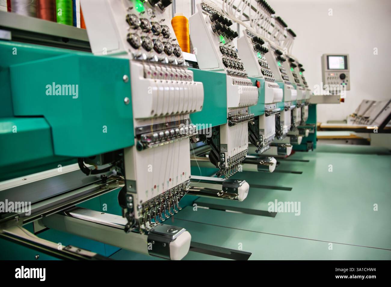 embroidery machine multiple head industrial, in a apparel factory Stock ...
