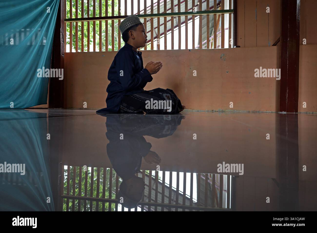 March 8, 2025, Aceh Besar, Aceh, Indonesia: A child is praying at the ...