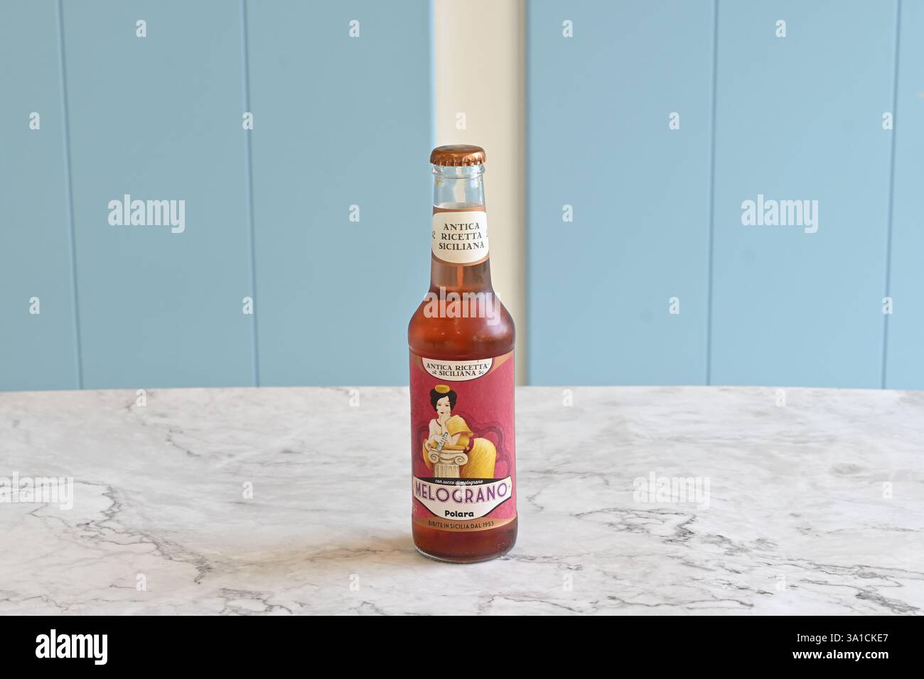 A bottle of beer with a woman on the label. The bottle is sitting on a ...