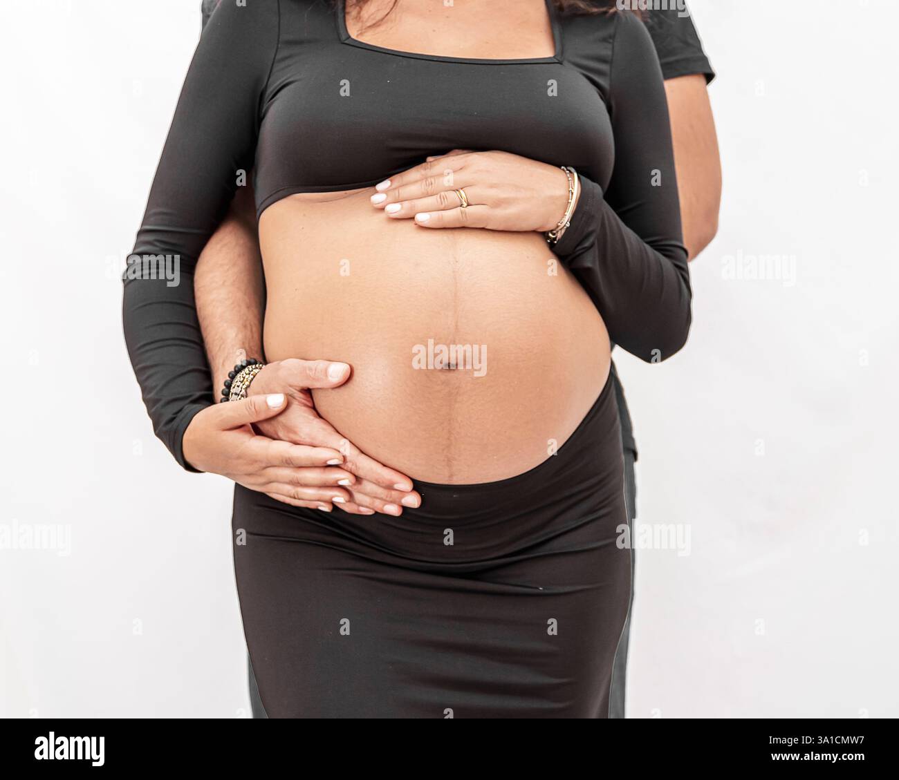 a future mother and a future father hug a tender belly Stock Photo - Alamy