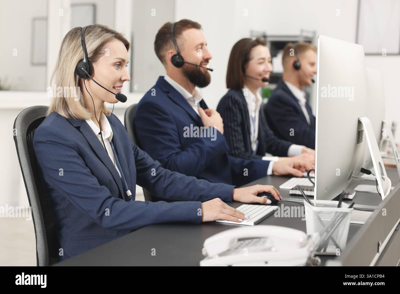 Technical support call center. Team of operators working in office ...