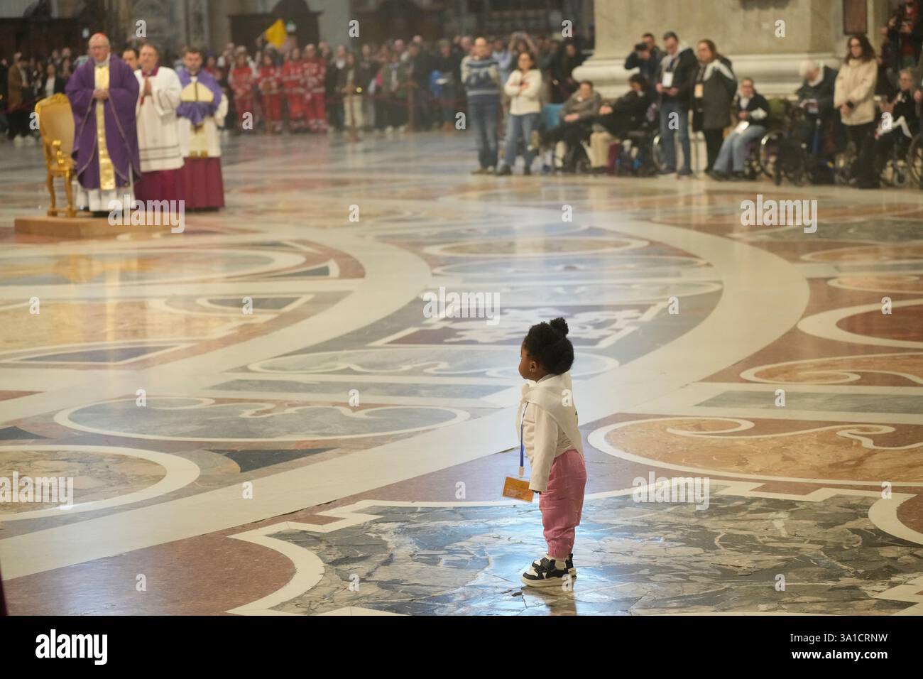 A child follows Vatican Secretary of State, Cardinal Pietro Parolin ...