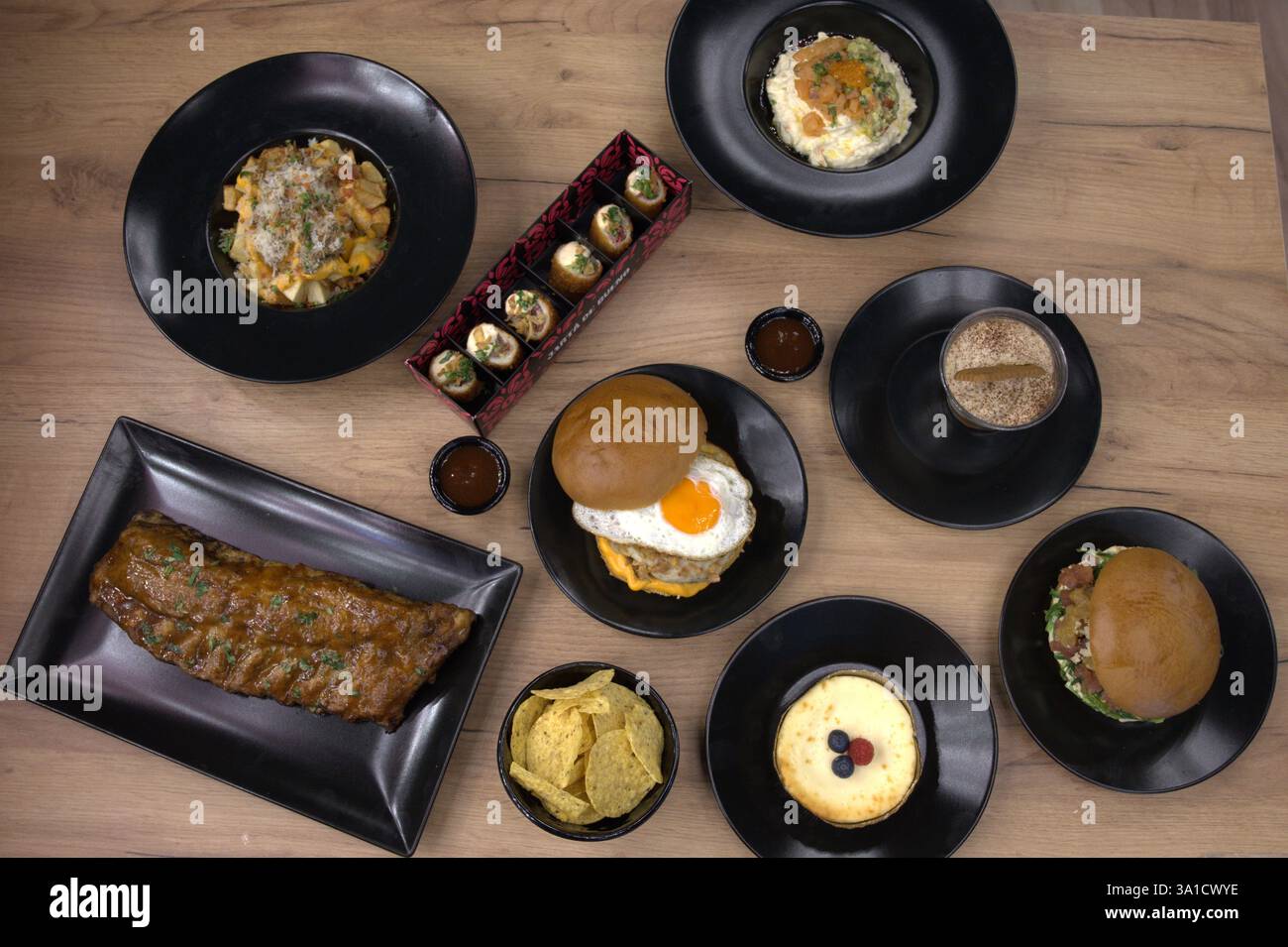 A table full of food with a variety of dishes including sandwiches ...