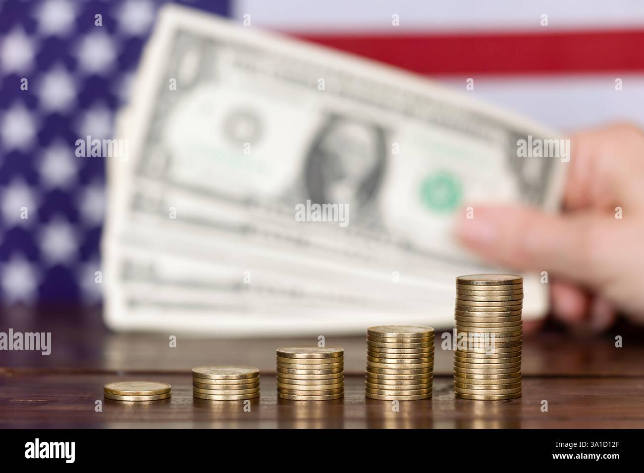 Hand holding dollar money banknotes behind coins. Compound interest ...