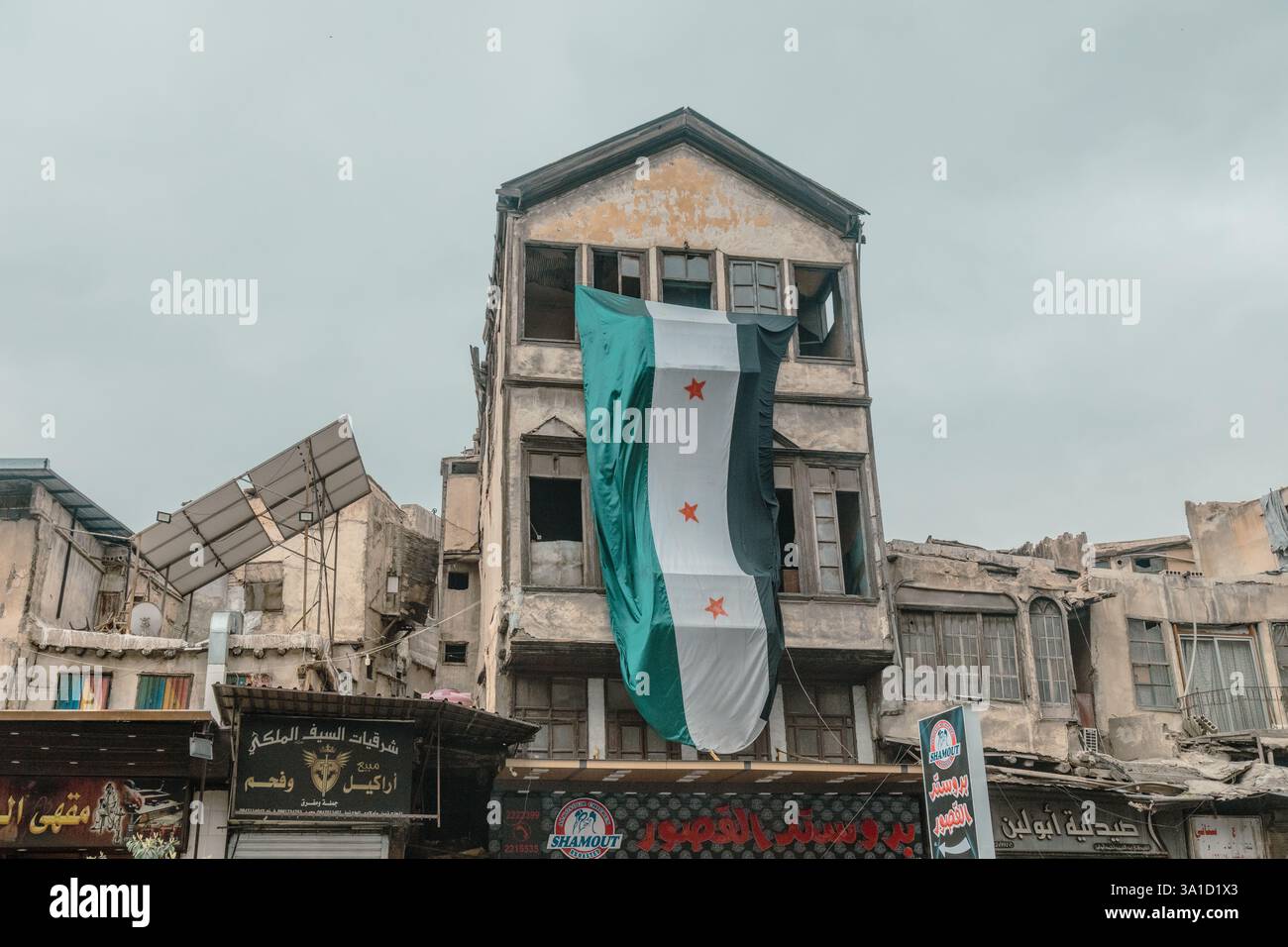 The Syrian flag is seen on a building in the city. Muslims in Syria are ...