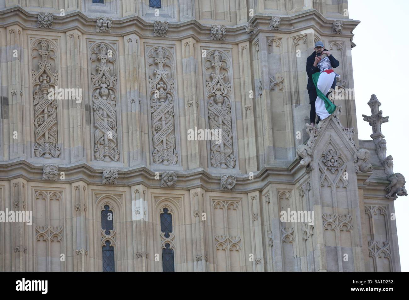 March 8, 2025, London, England, UK: A protester clings on to the ...