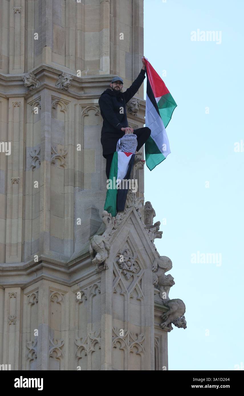 March 8, 2025, London, England, UK: A protester clings on to the ...