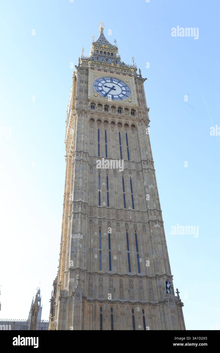 March 8, 2025, London, England, UK: A protester clings on to the ...