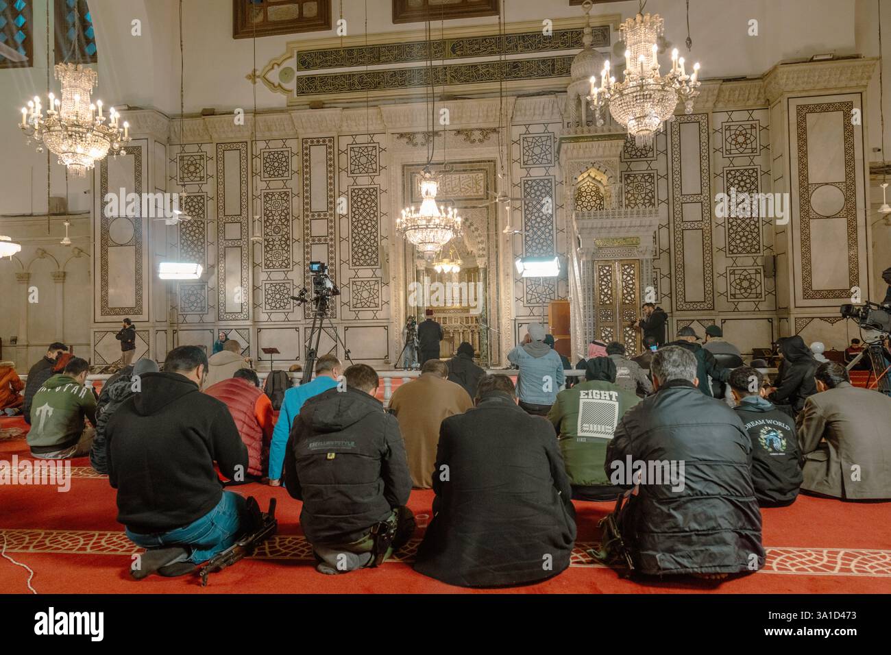 Damascus, Syria. 03rd Mar, 2025. Men with guns attend the sunset prayer ...