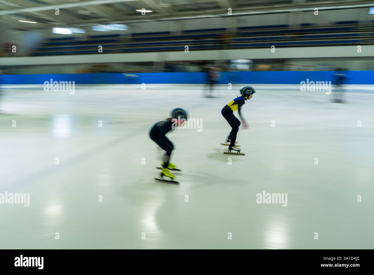 Ice Speed Skating. Children on the ice arena. Skates Sport child ...