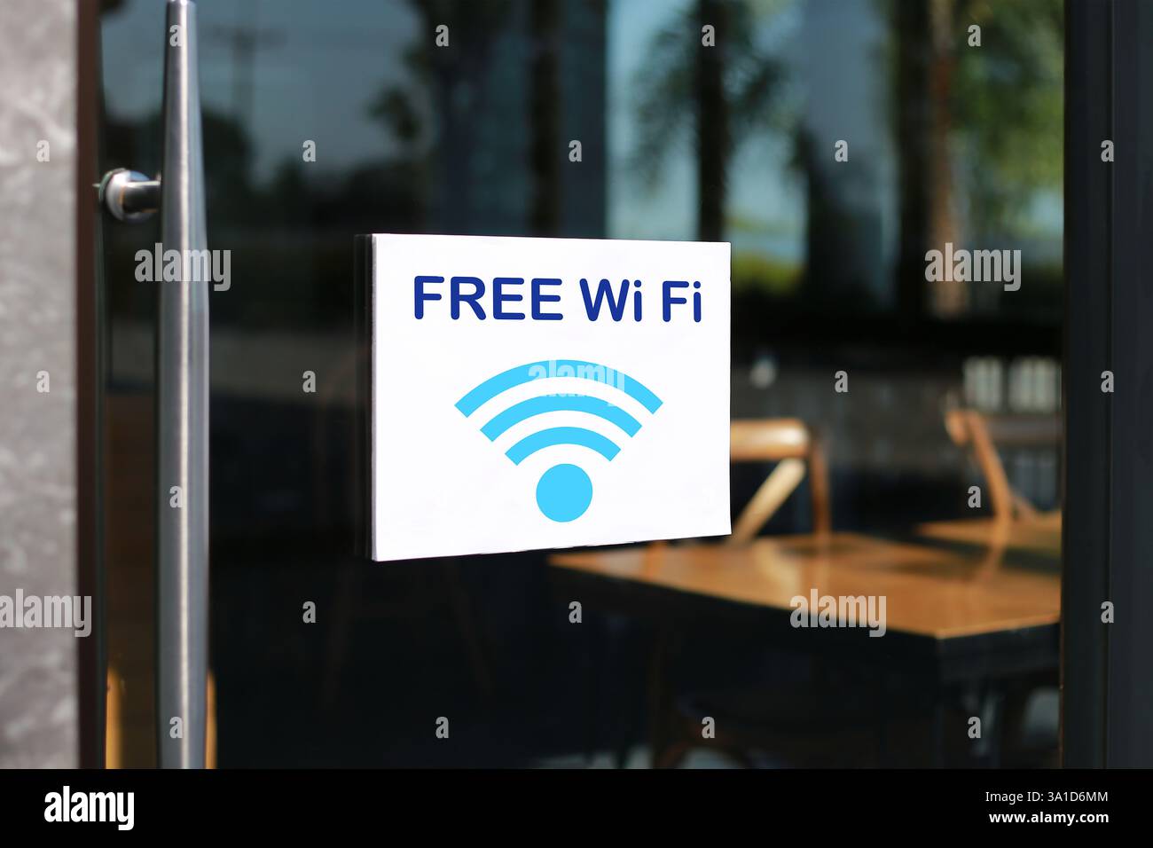 A free Wi-Fi sign is posted on the glass door in front of the ...