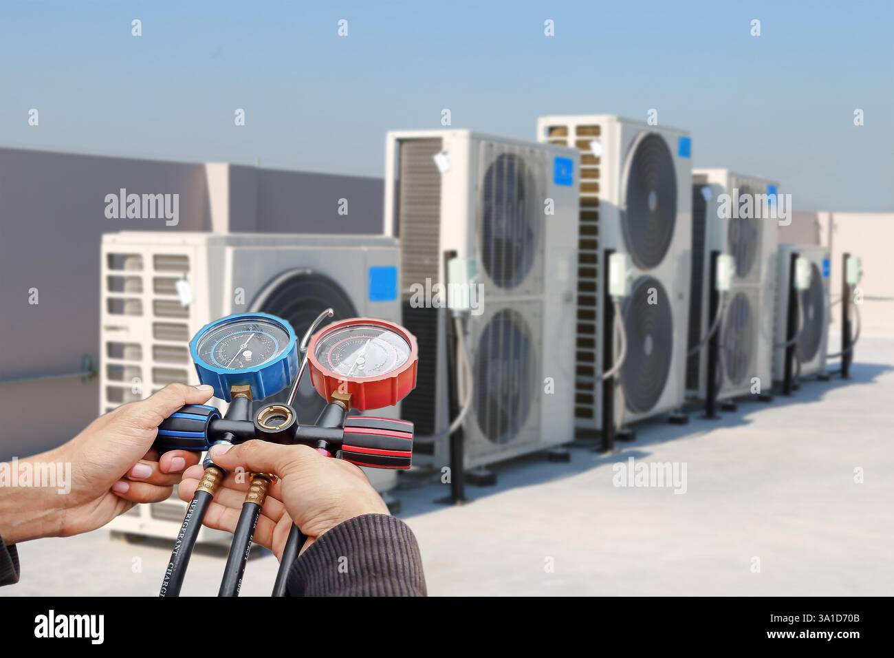 Air conditioning, HVAC service technician using gauges to check ...