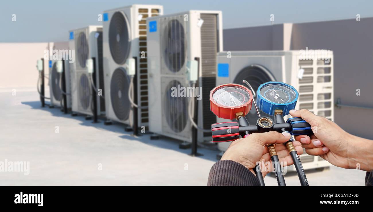 Air conditioning, HVAC service technician using gauges to check ...