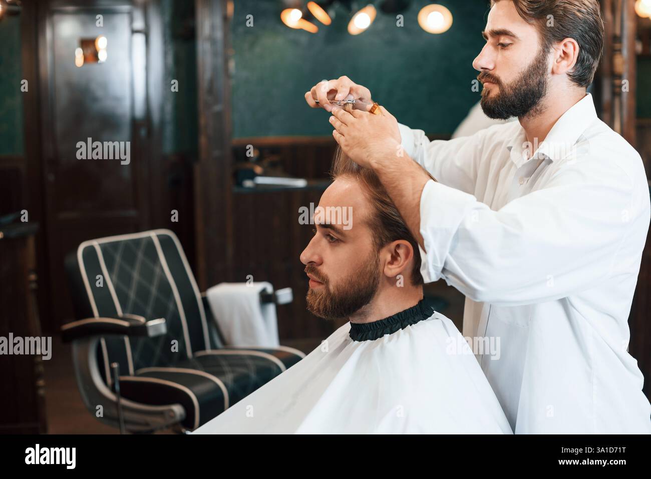 Professional haircut. Man is visiting modern barber shop. Modern style ...