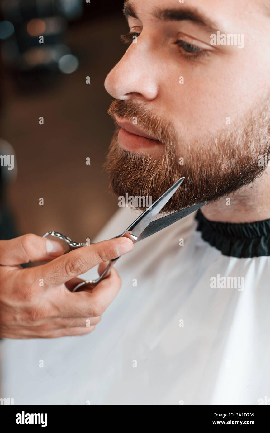 Using scissors. Man is visiting modern barber shop. Modern style Stock ...