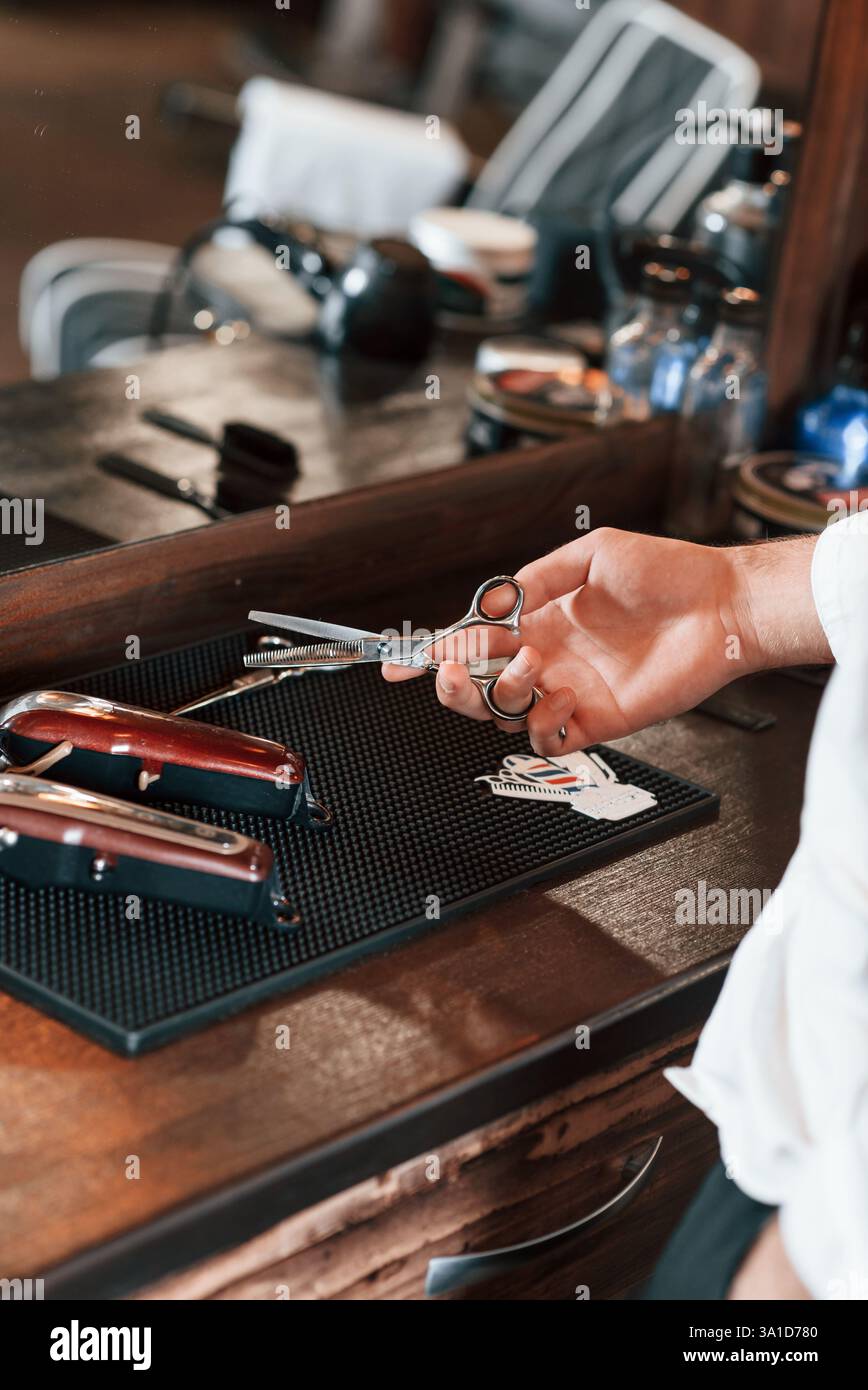 Close up view of barber hand that is holding scissors Stock Photo - Alamy
