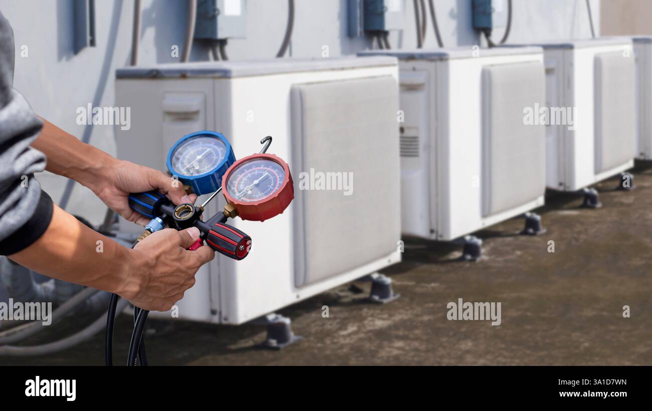 Air conditioning, HVAC service technician using gauges to check ...