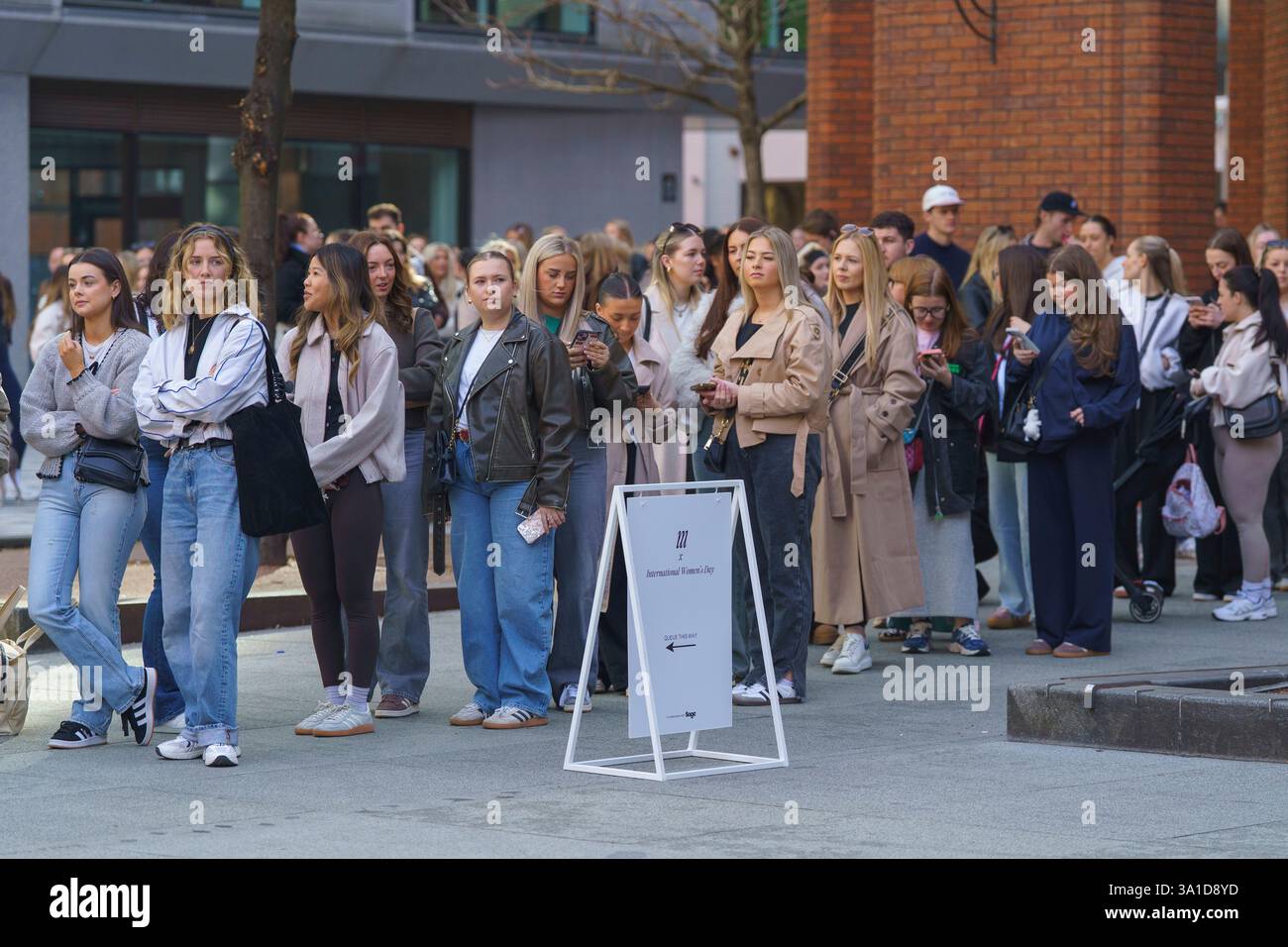 EDITORIAL USE ONLY Members of the public queue as influencer Molly-Mae ...