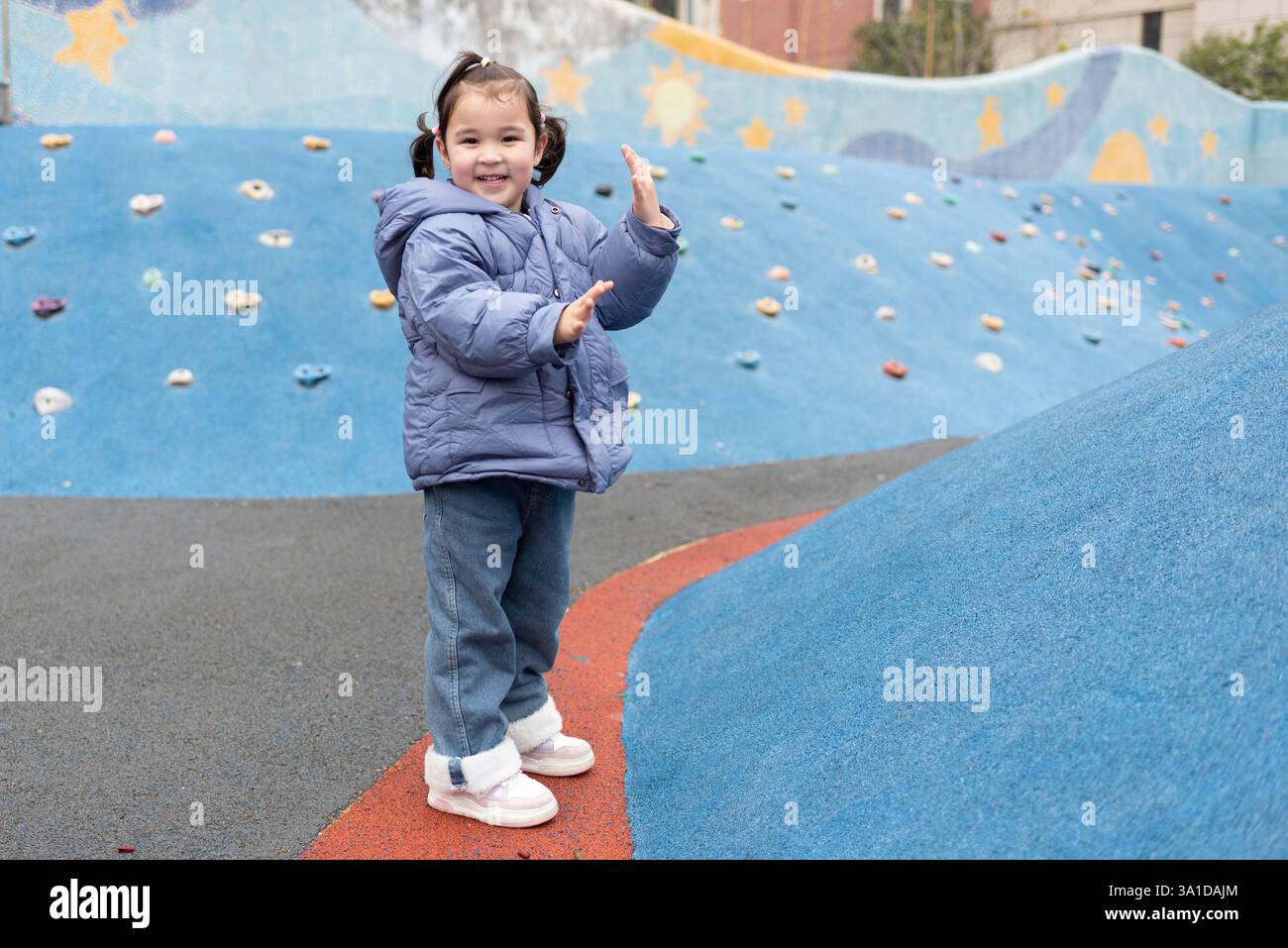 Small Chinese girl playing hide and seek at a local playground Stock ...