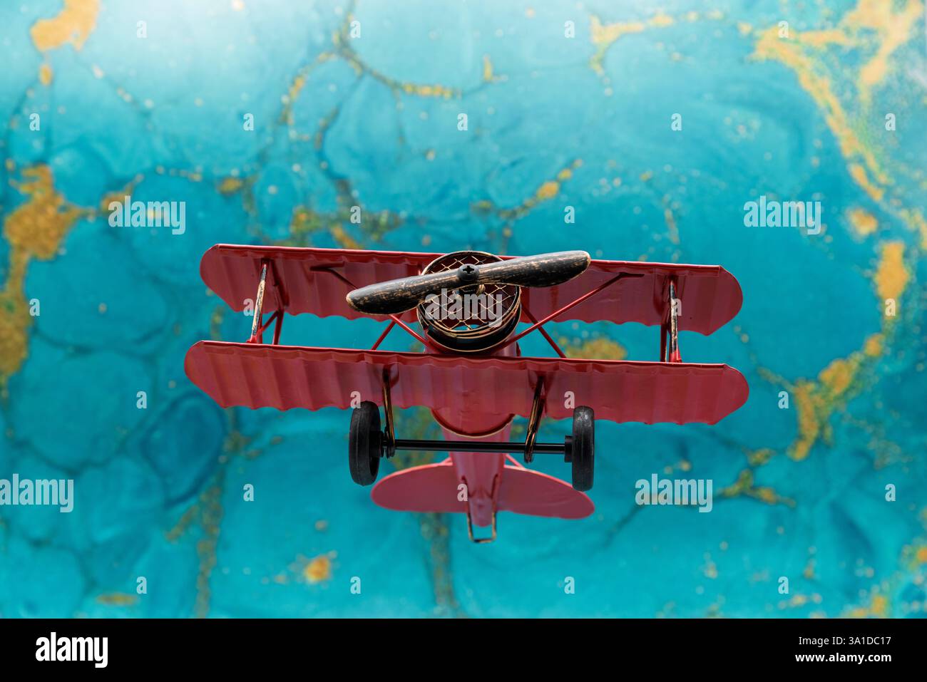 Avión biplano clásico pintado de rojo de hélice, con fondo azul ...