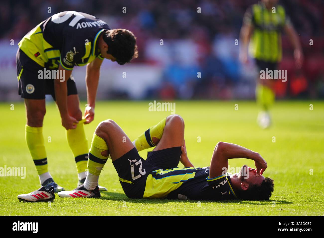 Manchester City's Matheus Nunes lies in pain after picking up an injury ...