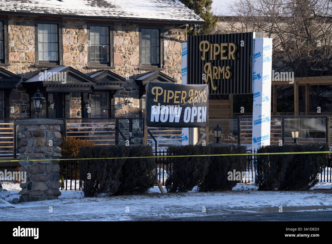 Police tape marks the scene of a shooting at a pub in Toronto, Canada, Saturday, March 8, 2025 ...