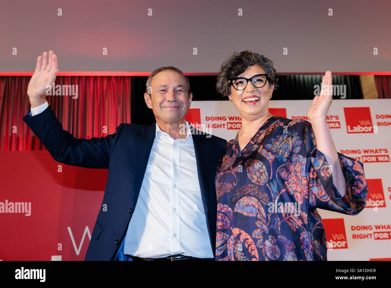 Western Australia Premier, Roger Cook is seen on stage with his wife ...