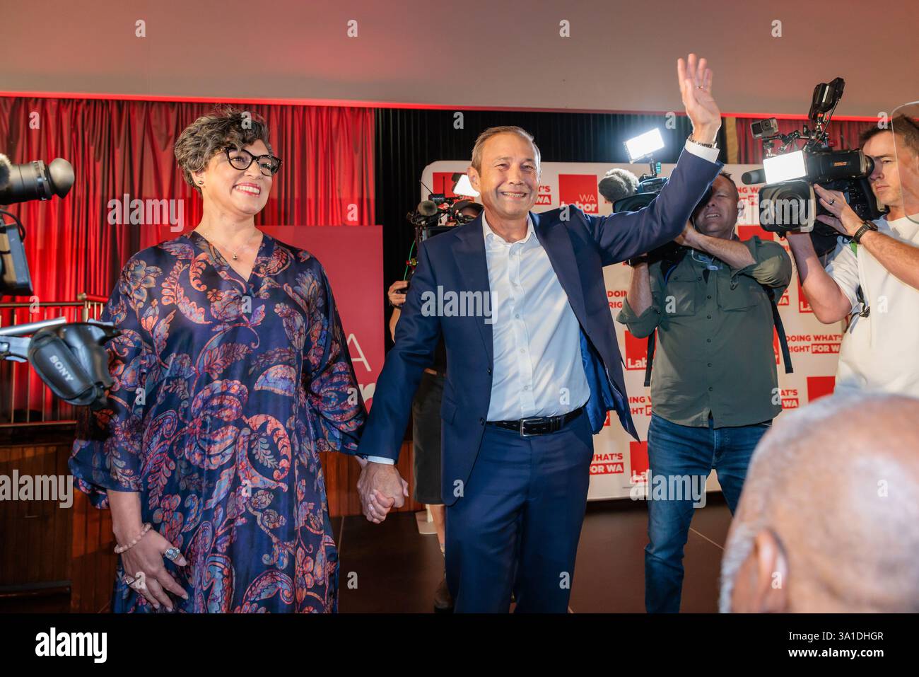 Western Australia Premier, Roger Cook is seen on stage with his wife ...