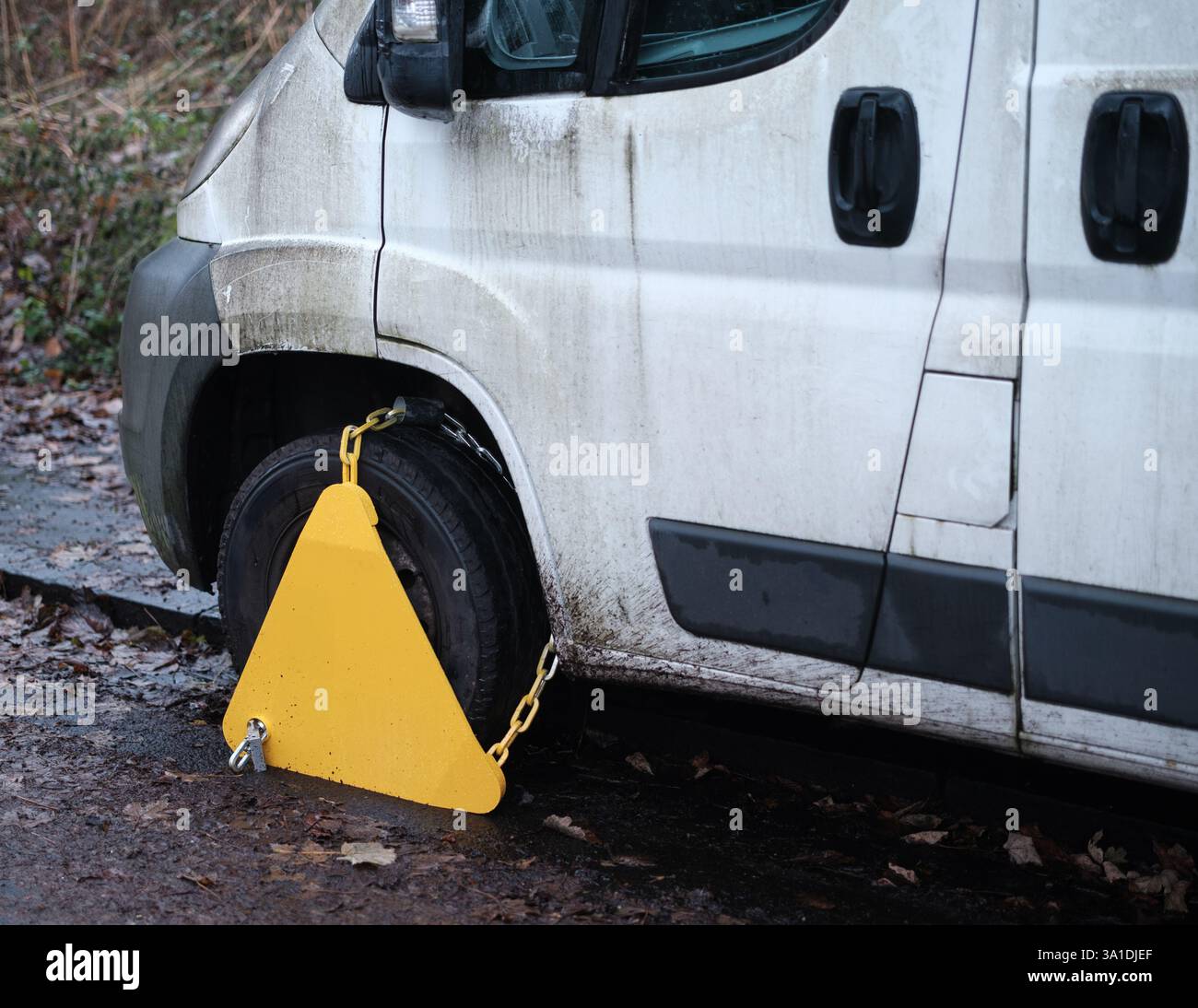 A Grungy White Work Van With A Wheel Clamp Or Boot Stock Photo - Alamy