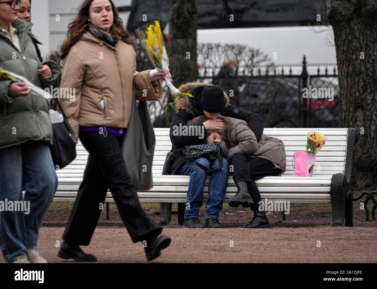 A couple rest in a park on International Women's Day in St. Petersburg ...