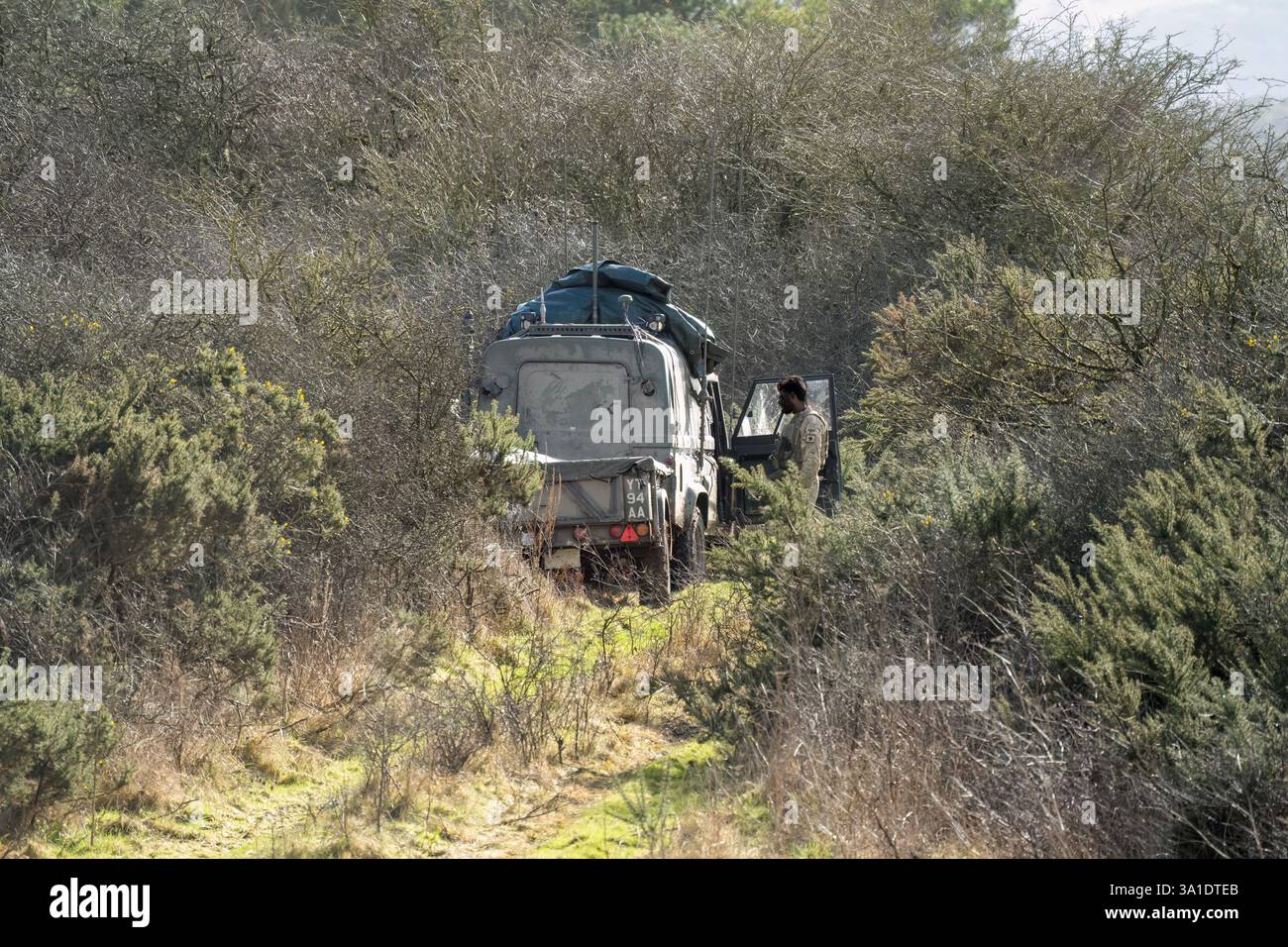 British army Land Rover Wolf utility with attached trailer amongst ...
