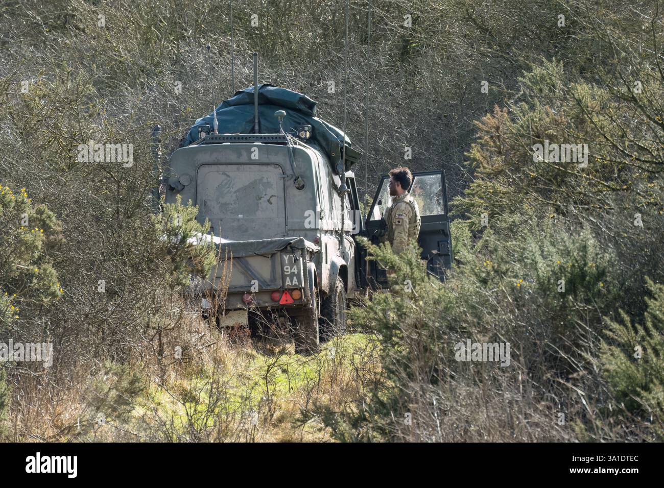British army Land Rover Wolf utility with attached trailer amongst ...