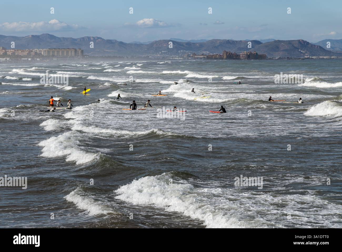 Valencia, Spain - February 23, 2025: Surfers dot the ocean landscape ...