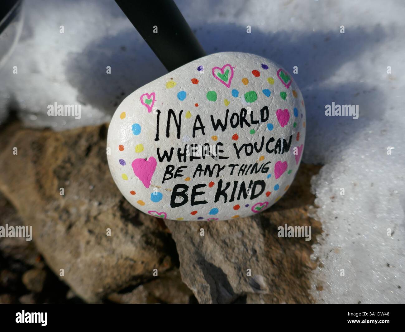Be kind kindness rock on stone with snow Stock Photo - Alamy