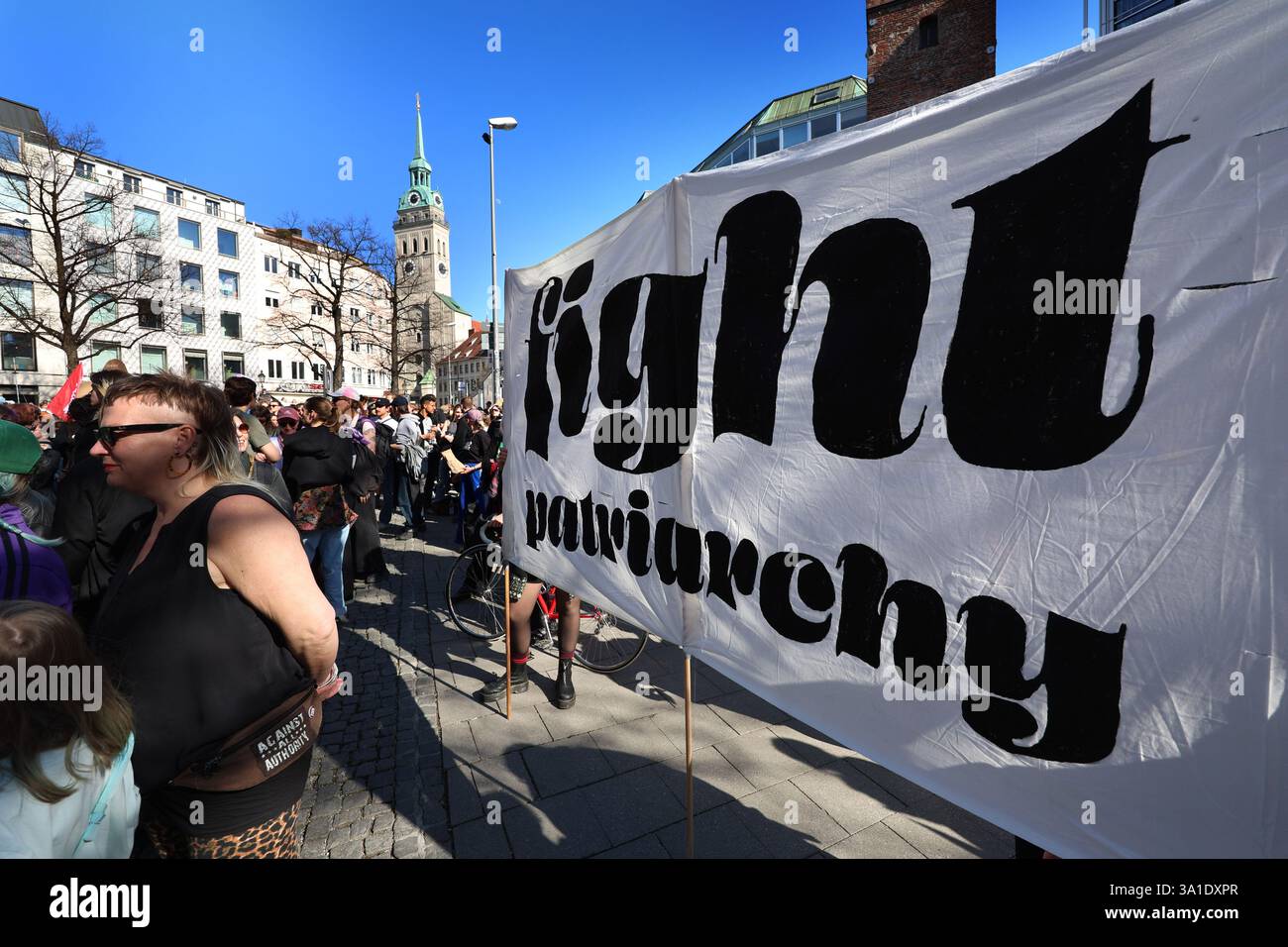 08 March 2025, Bavaria, Munich: Demonstrators hold a banner with the ...
