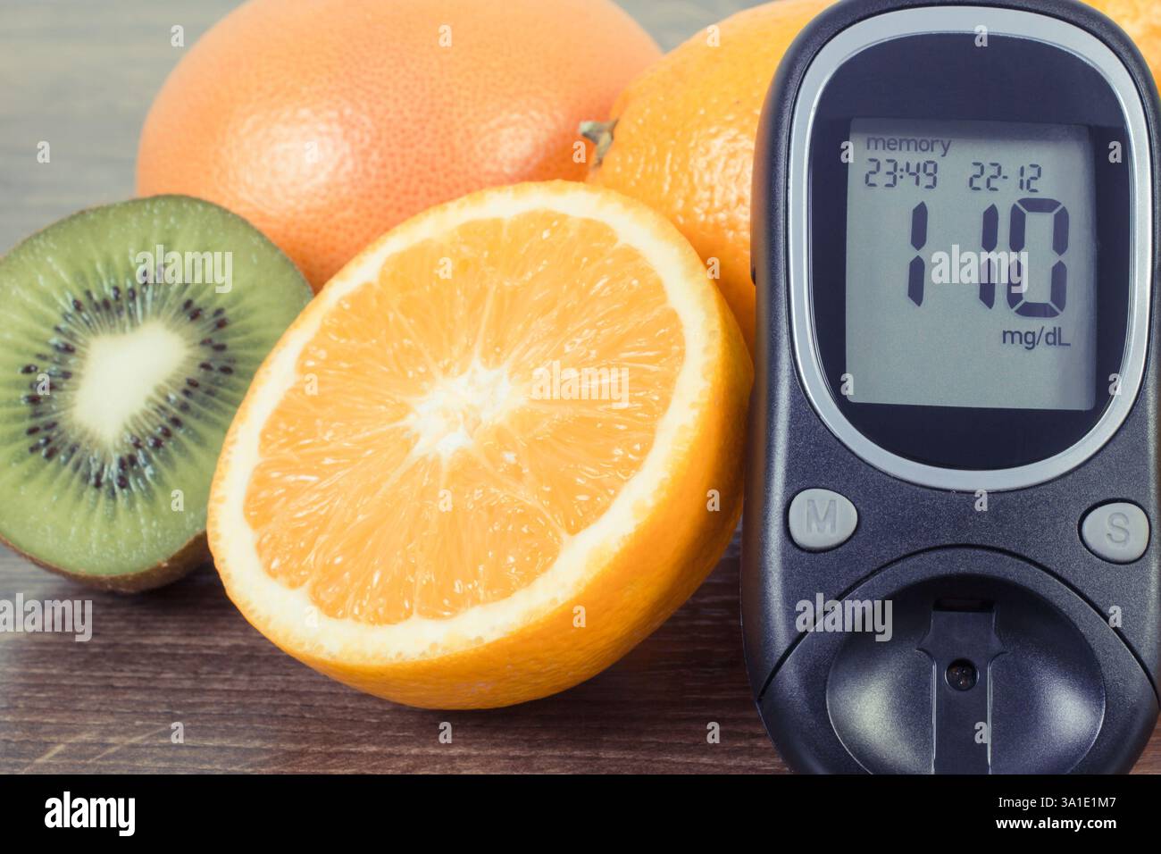 Glucose meter for measuring and checking sugar level, fresh ripe fruits ...