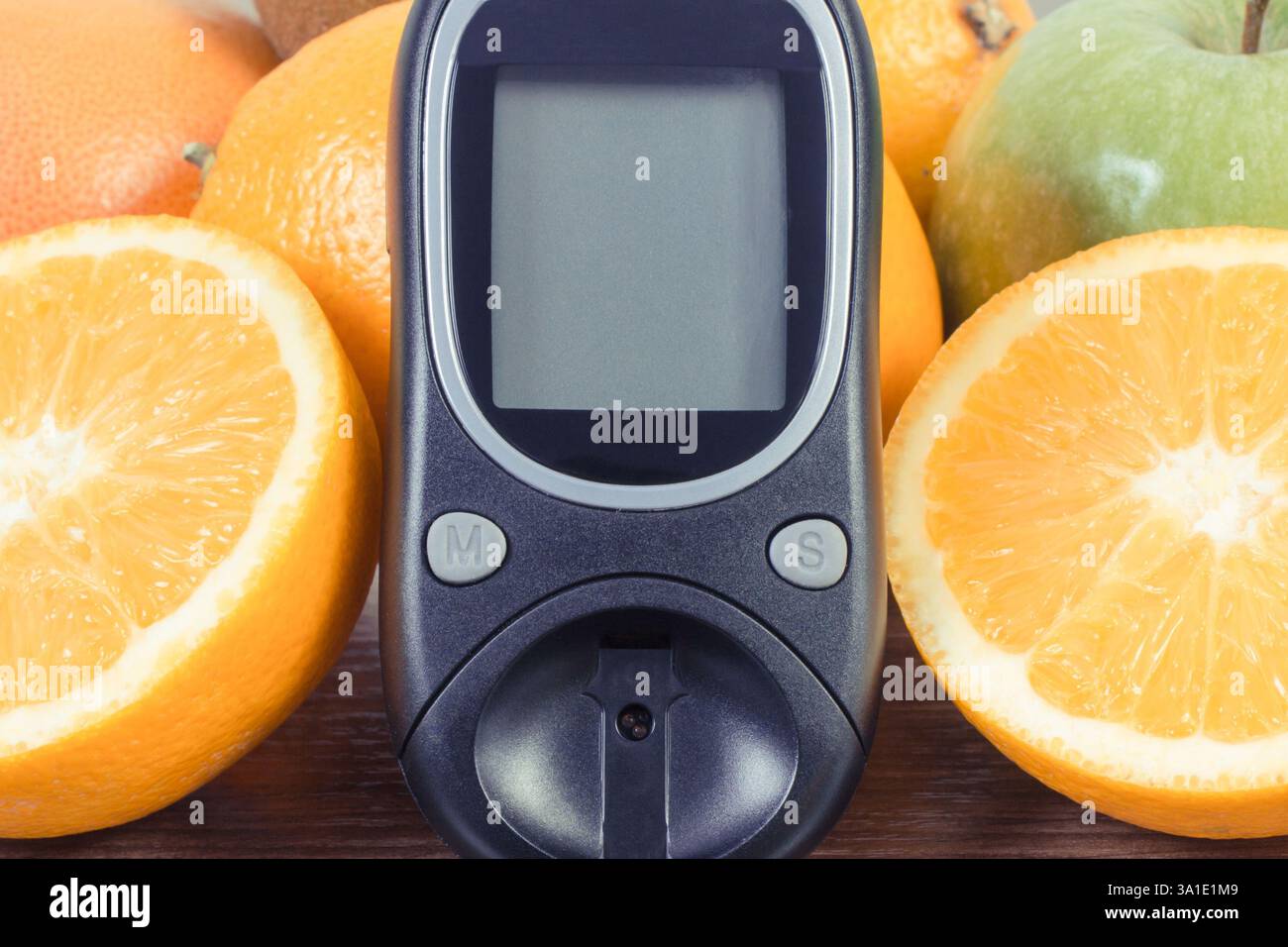 Glucose meter for measuring and checking sugar level, fresh ripe fruits ...