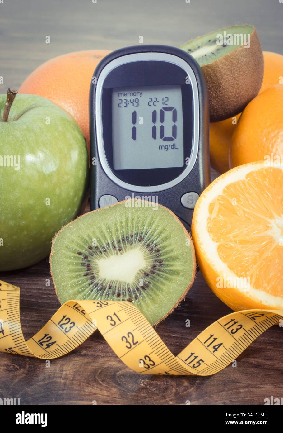 Glucometer, fresh ripe fruits and orange juice. Healthy lifestyle and ...
