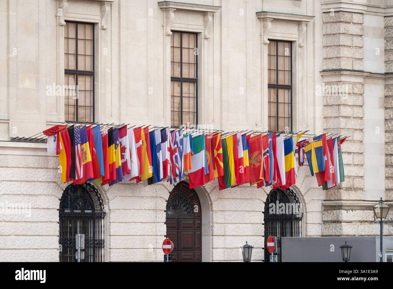 International flags on the facade of a historic building in Vienna ...