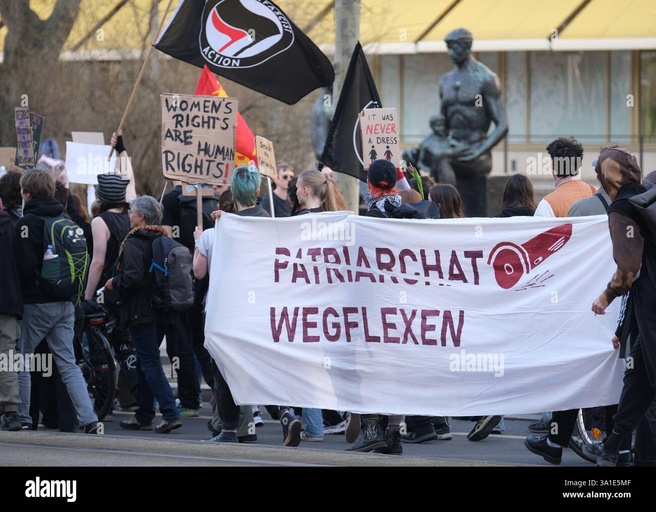 Leipzig, Germany. 08th Mar, 2025. Participants hold a banner with the ...