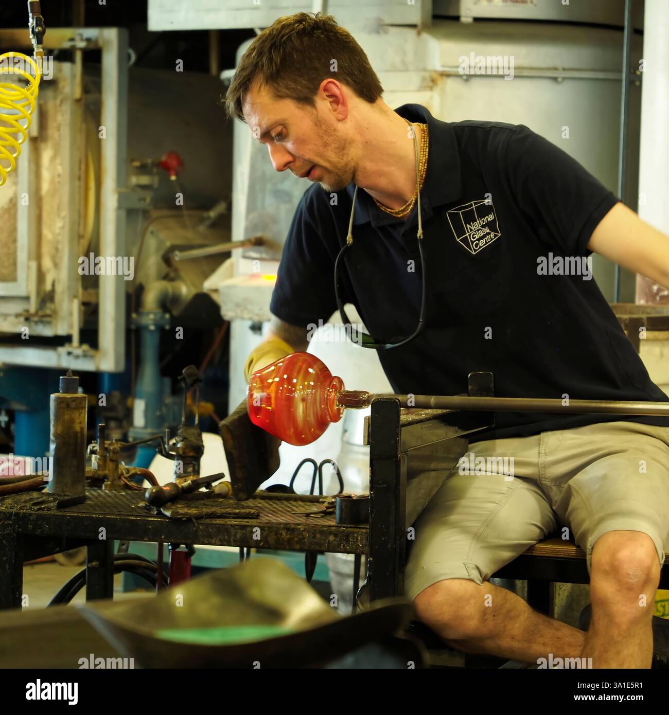 craftsman demonstrates the art of glassblowing at the National Glass ...
