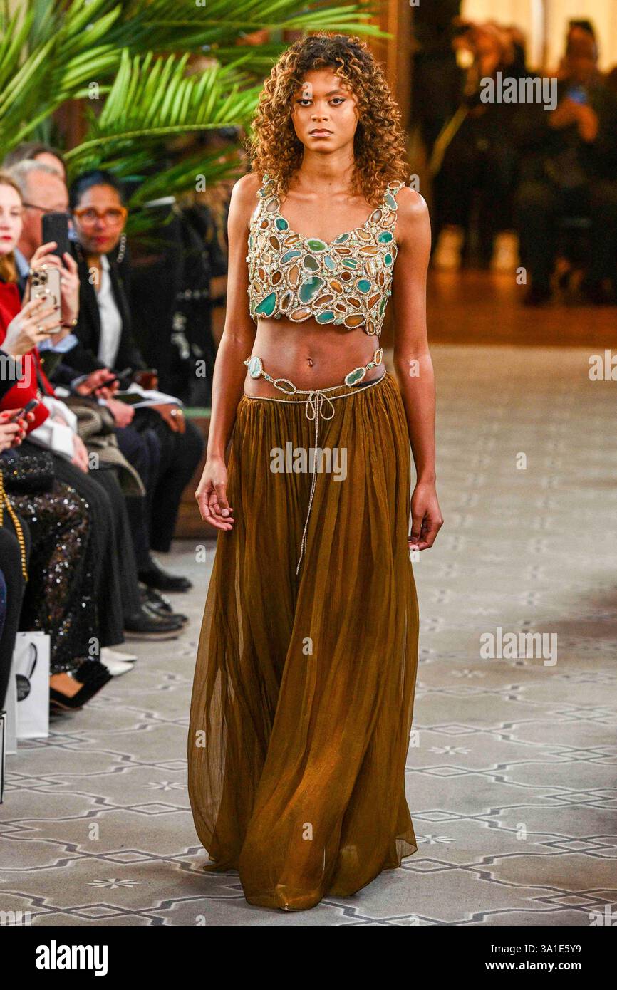 A model walks the runway during the Serbia Fashion Week Runway ...