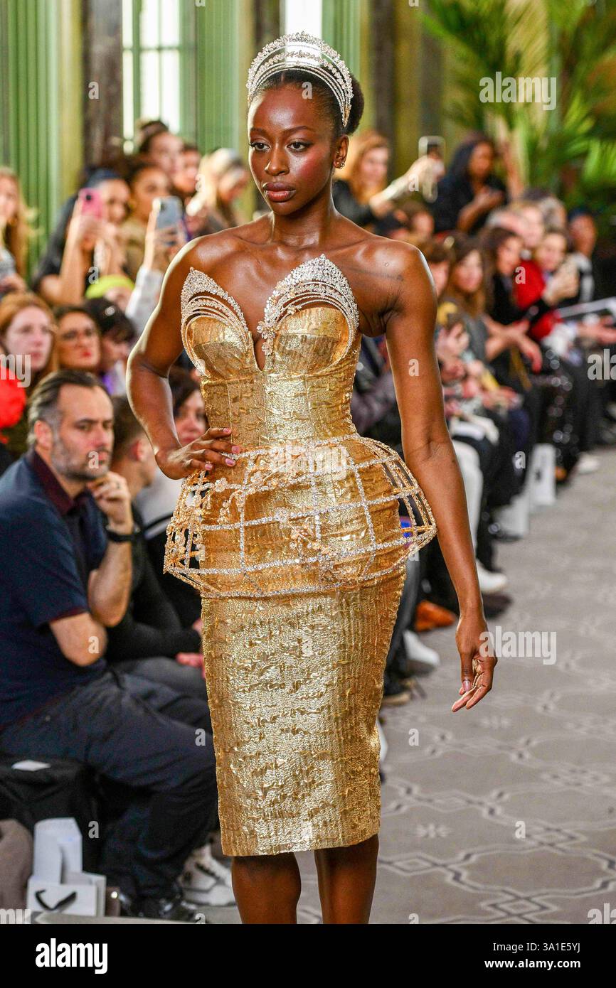 A model walks the runway during the Serbia Fashion Week Runway ...