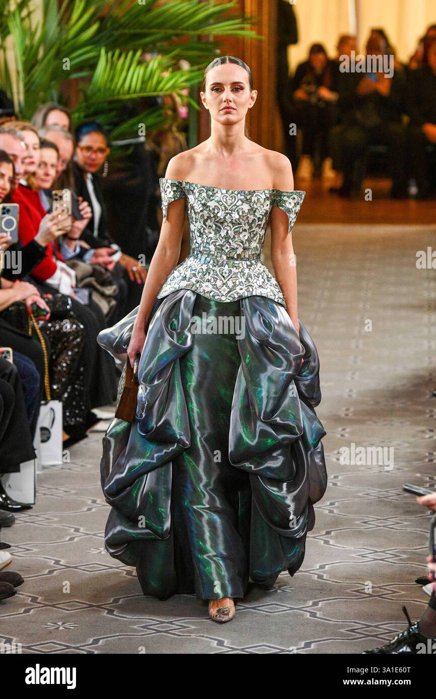 A model walks the runway during the Serbia Fashion Week Runway ...