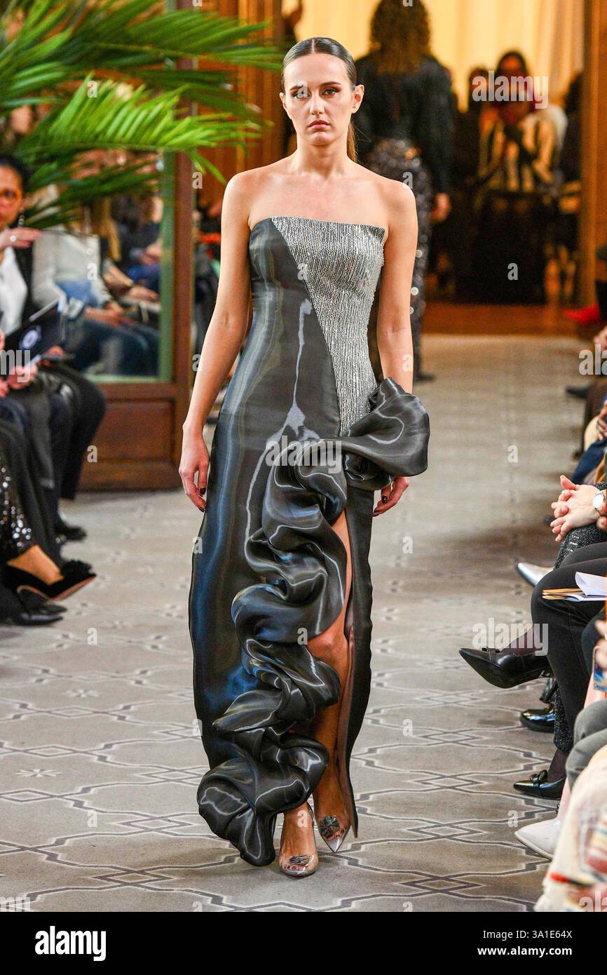 A model walks the runway during the Serbia Fashion Week Runway ...