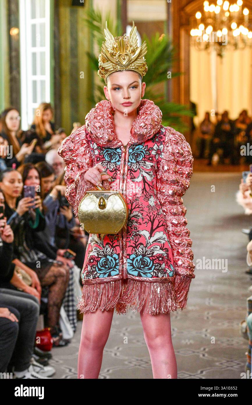 A model walks the runway during the Serbia Fashion Week Runway ...