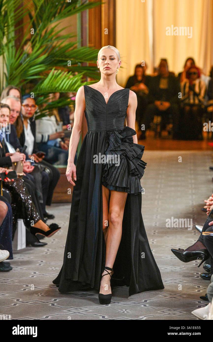A model walks the runway during the Serbia Fashion Week Runway ...