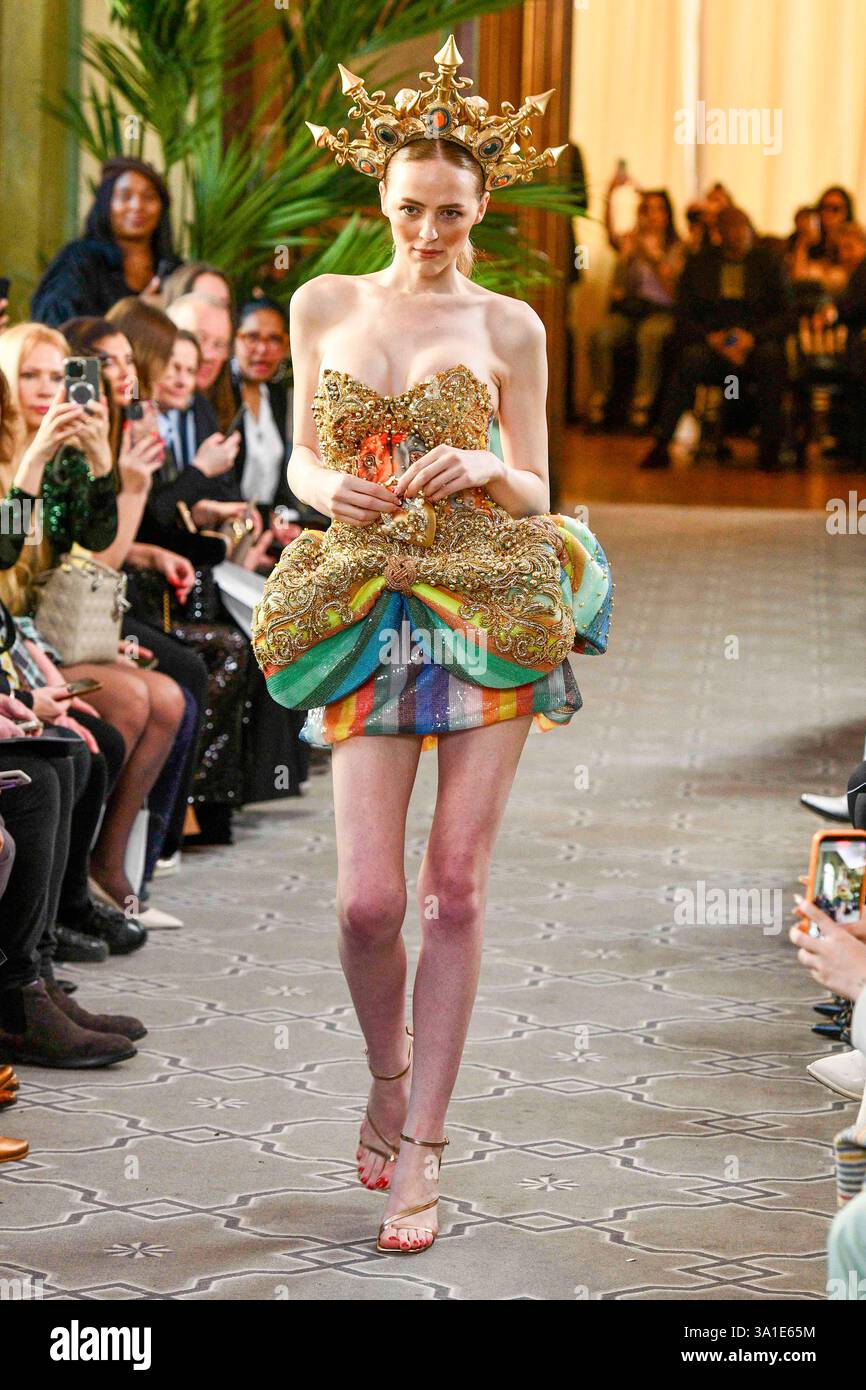 A model walks the runway during the Serbia Fashion Week Runway ...