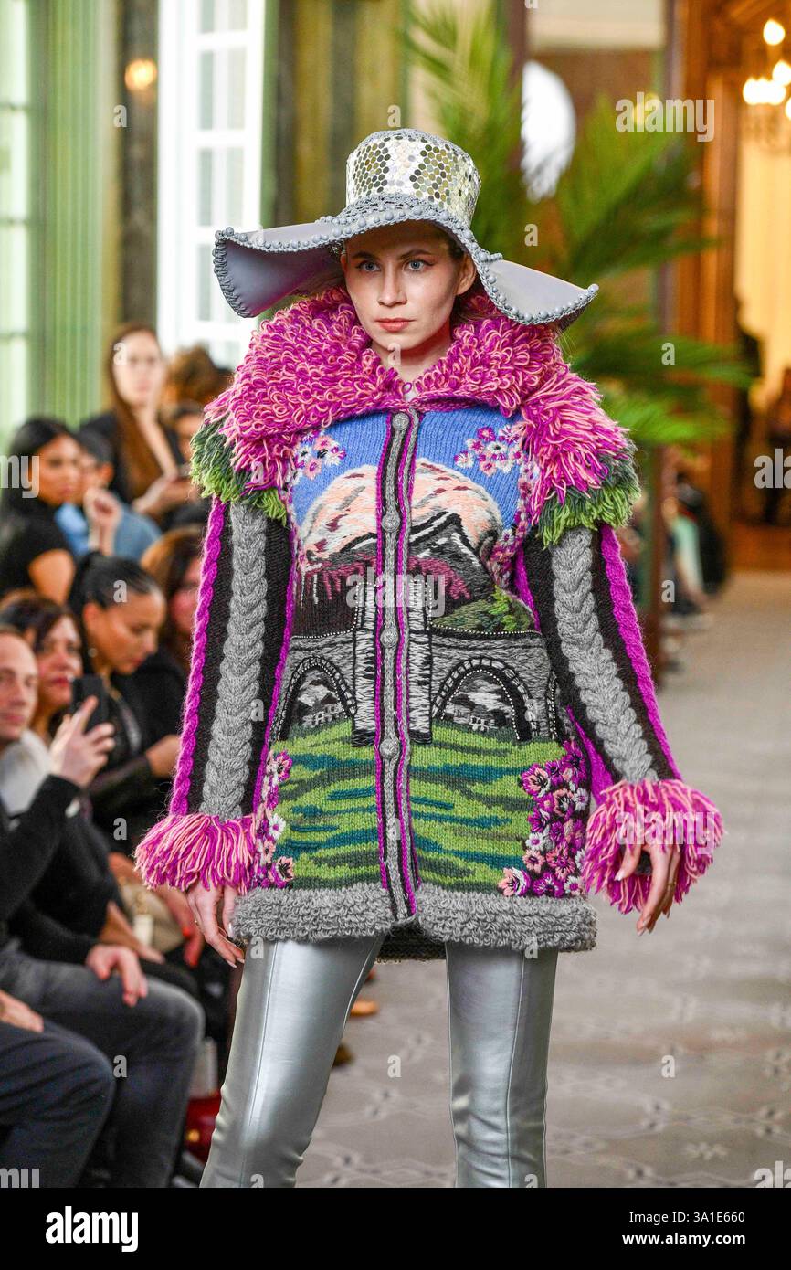 A model walks the runway during the Serbia Fashion Week Runway ...